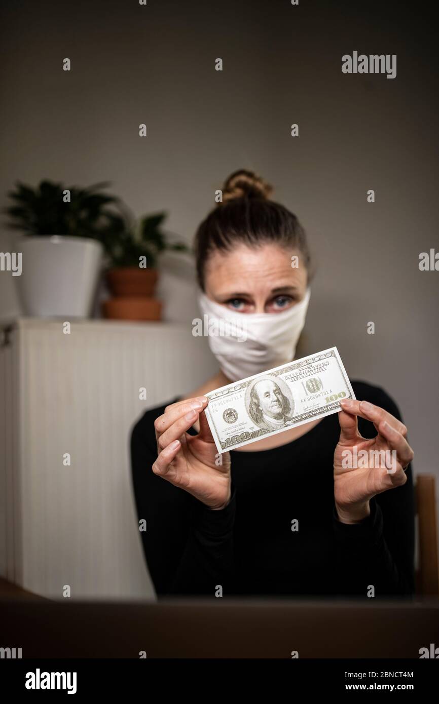 Single woman counting money bills during coronavirus time Stock Photo ...