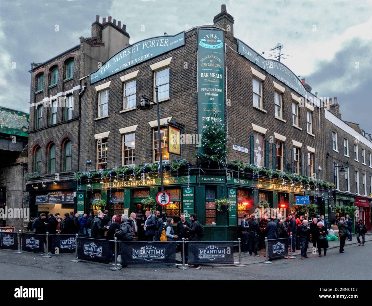 Christmas at Borough Market, London, England. The Shard building towers ...