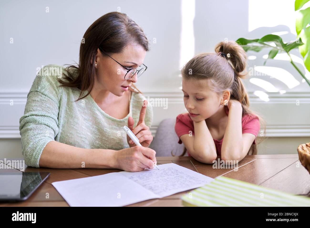 Mother and daughter child study together at home Stock Photo - Alamy