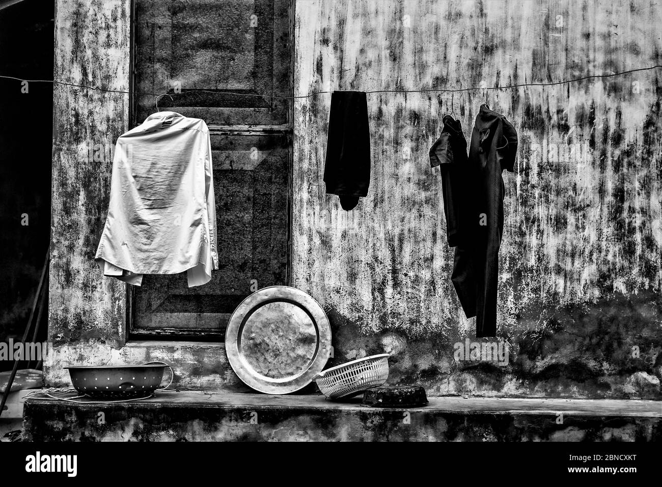Grayscale shot of clothes hanging on a wire Stock Photo - Alamy