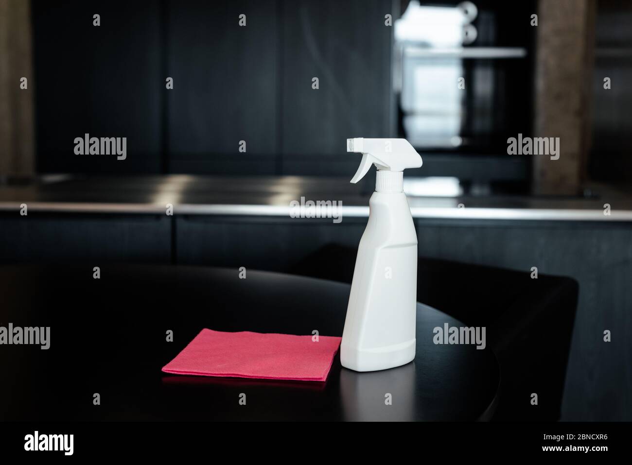 pink rag and spray bottle for cleaning on dark table Stock Photo - Alamy