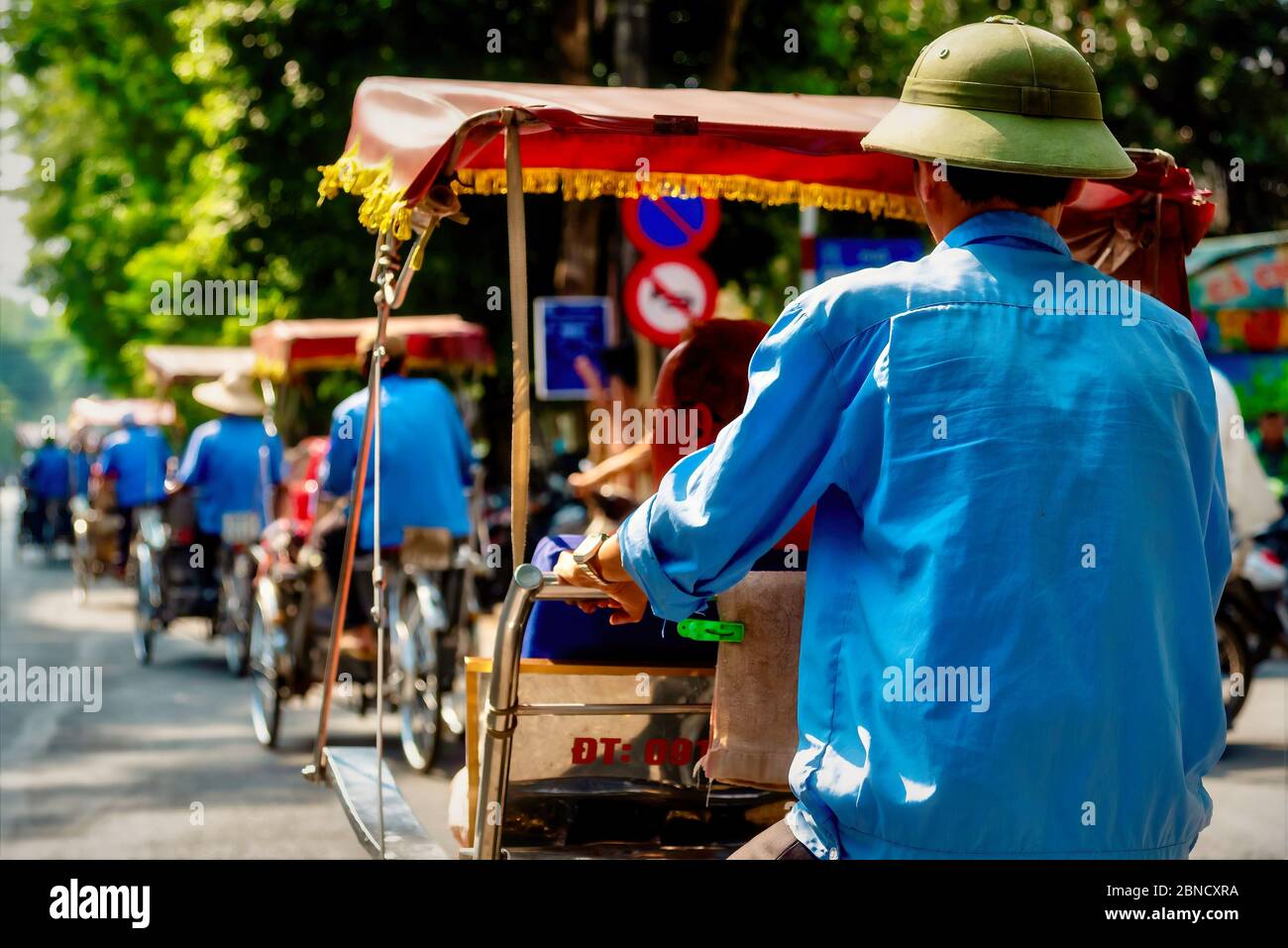 Beautiful shot of a male riding his rickshaw taken from behind Stock ...