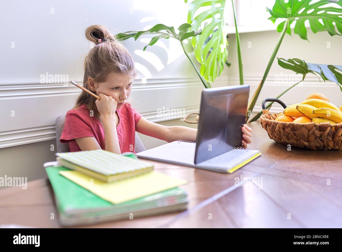 Girl child studying at home using digital tablet Stock Photo - Alamy