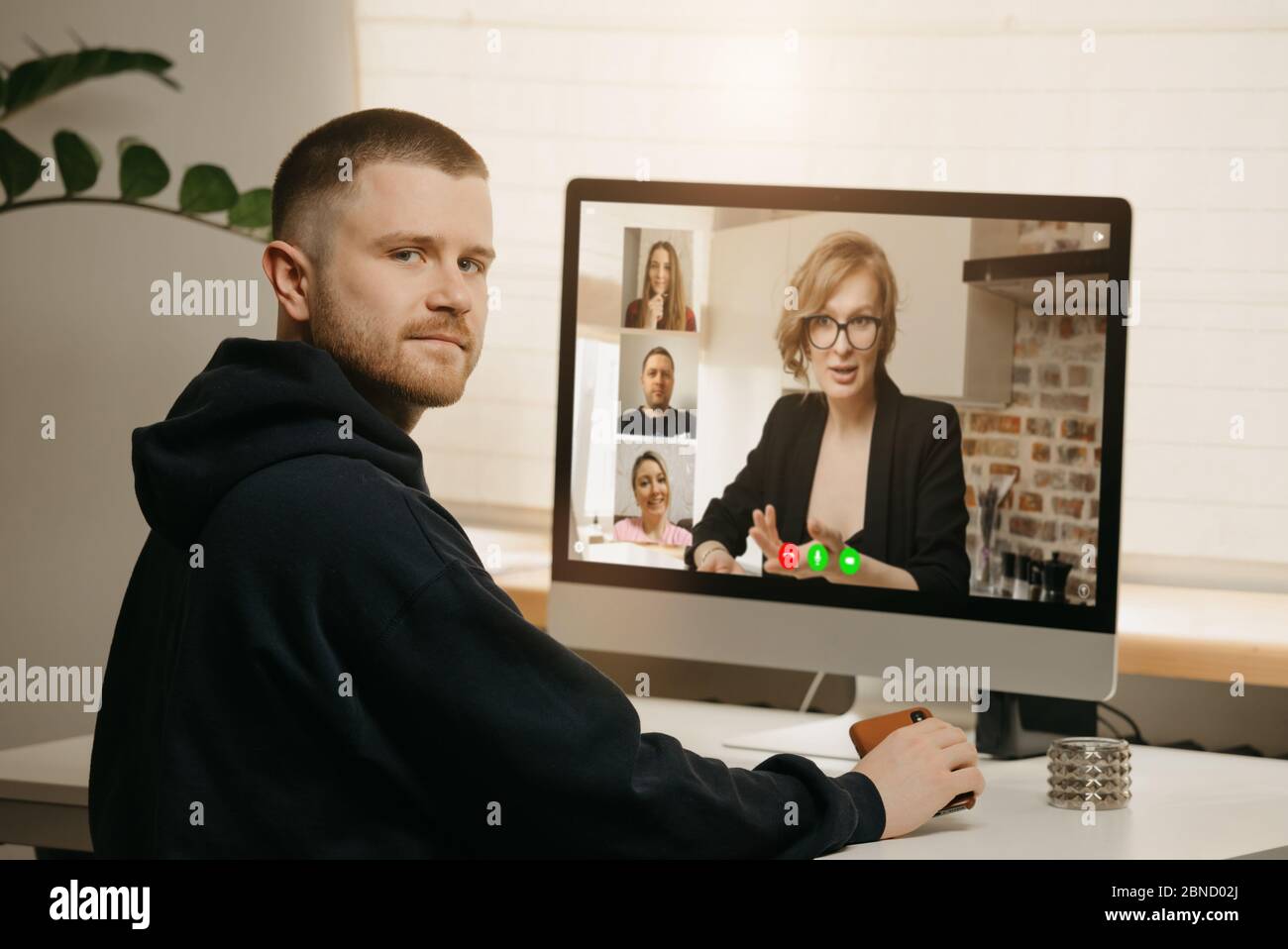 A back view of a man during a video call with his colleagues Stock ...
