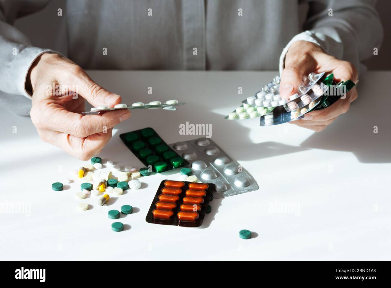 old woman hands close up take a pill from a blister of medicine ...