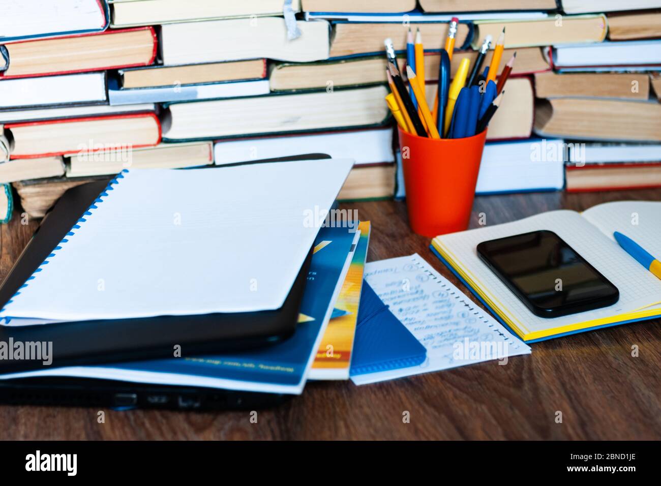 Textbook, notebook, laptop computer, mobile phone smartphone, stack of ...