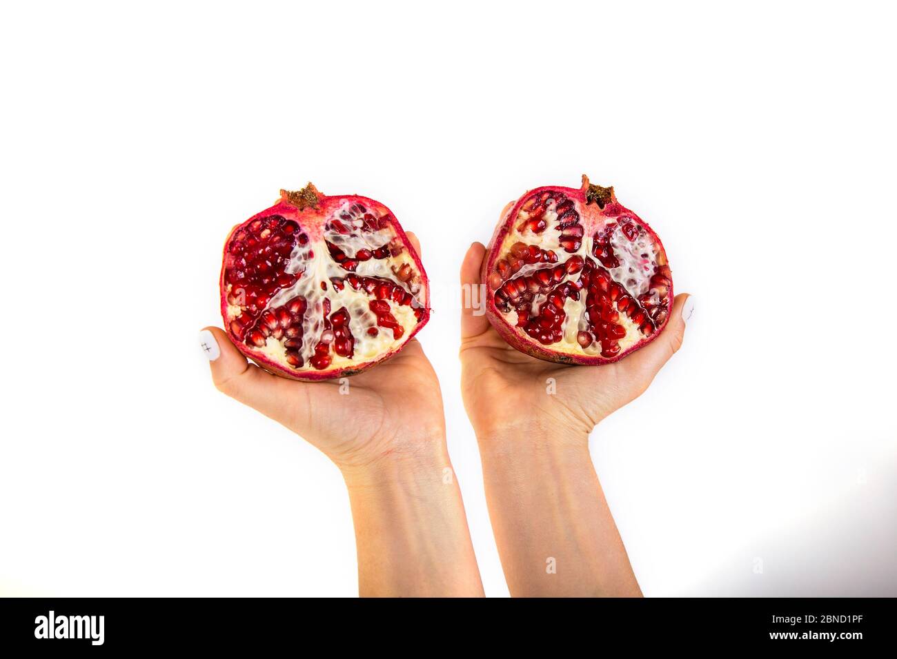 Hand holding a halfed pomegranate isolated on white background Stock ...