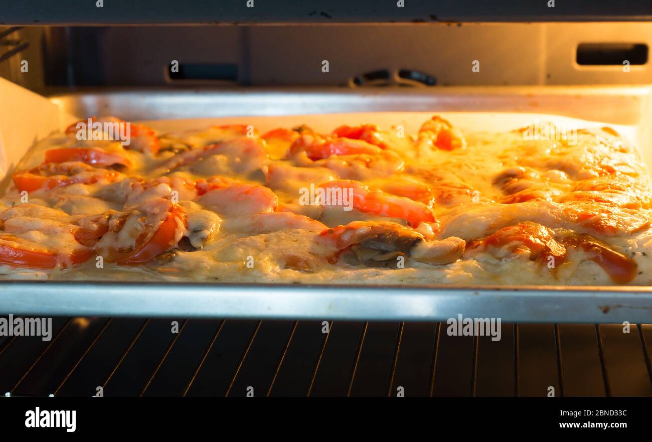fresh pizza is cooked in a hot oven Stock Photo - Alamy