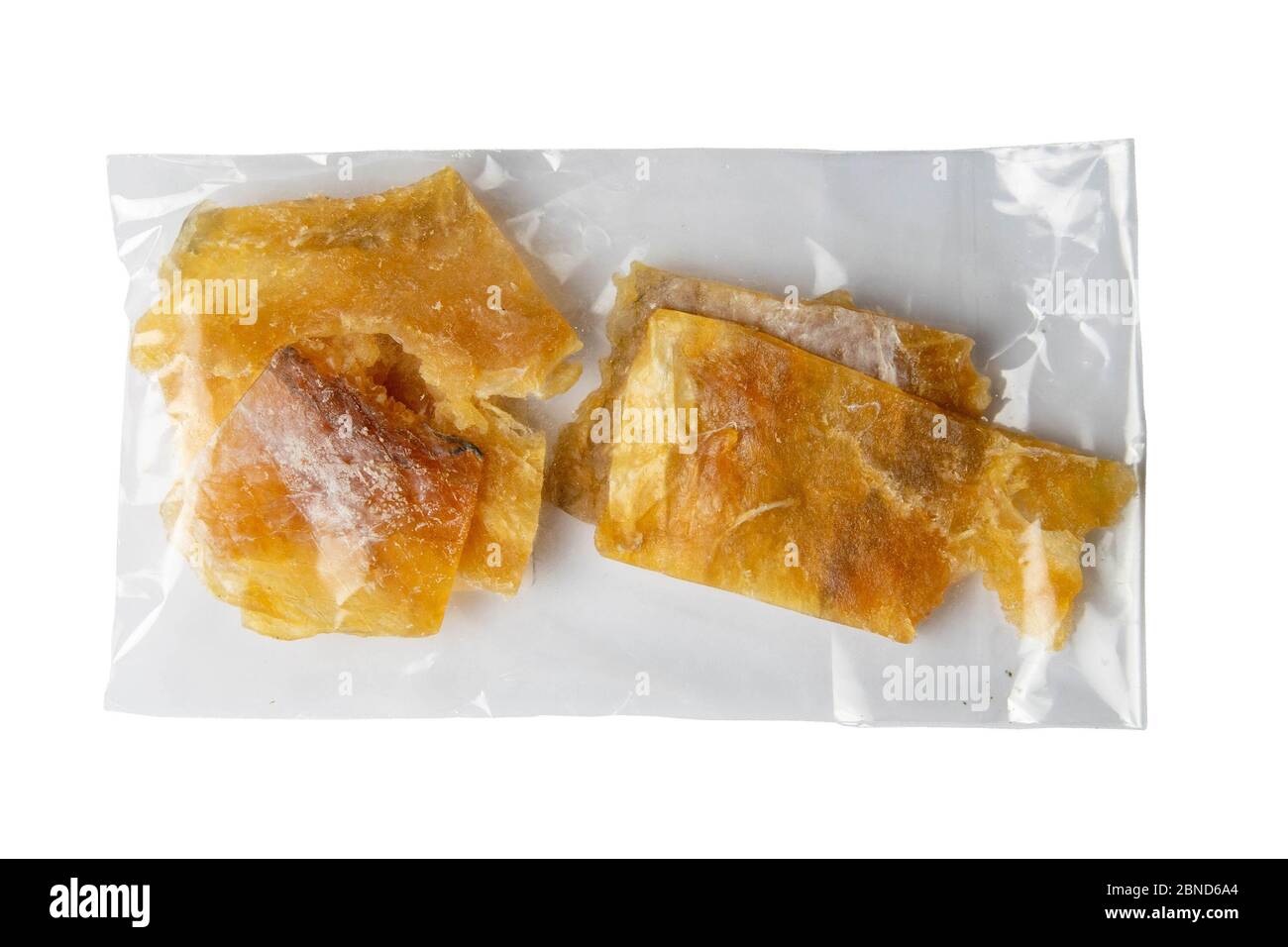 Dried cod fillet in a transparent package appetizer to beer on white ...