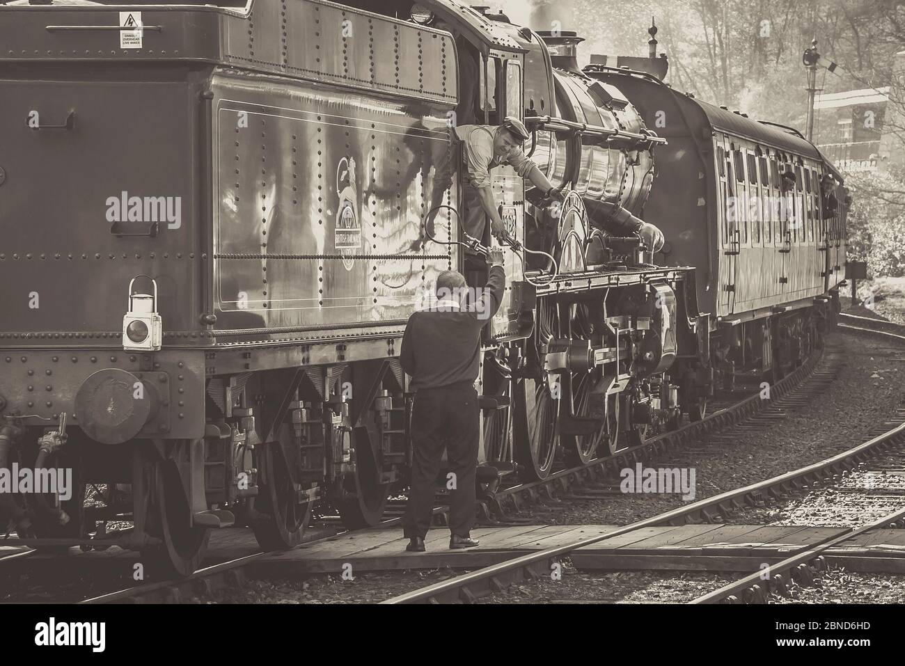 Vintage UK steam train crew exchanging railway token with station ...
