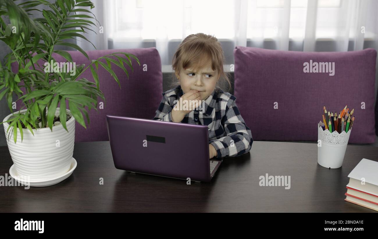 Pretty preschool girl distance online learning at home. Focused cute ...