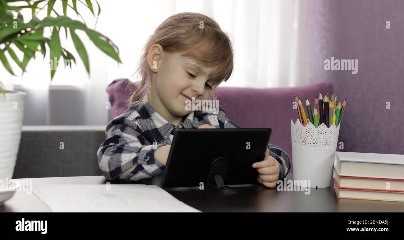 Pretty preschool girl distance online learning at home. Focused cute ...