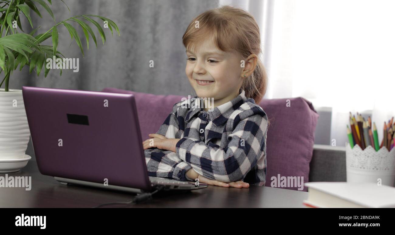 Pretty preschool girl distance online learning at home. Focused cute ...