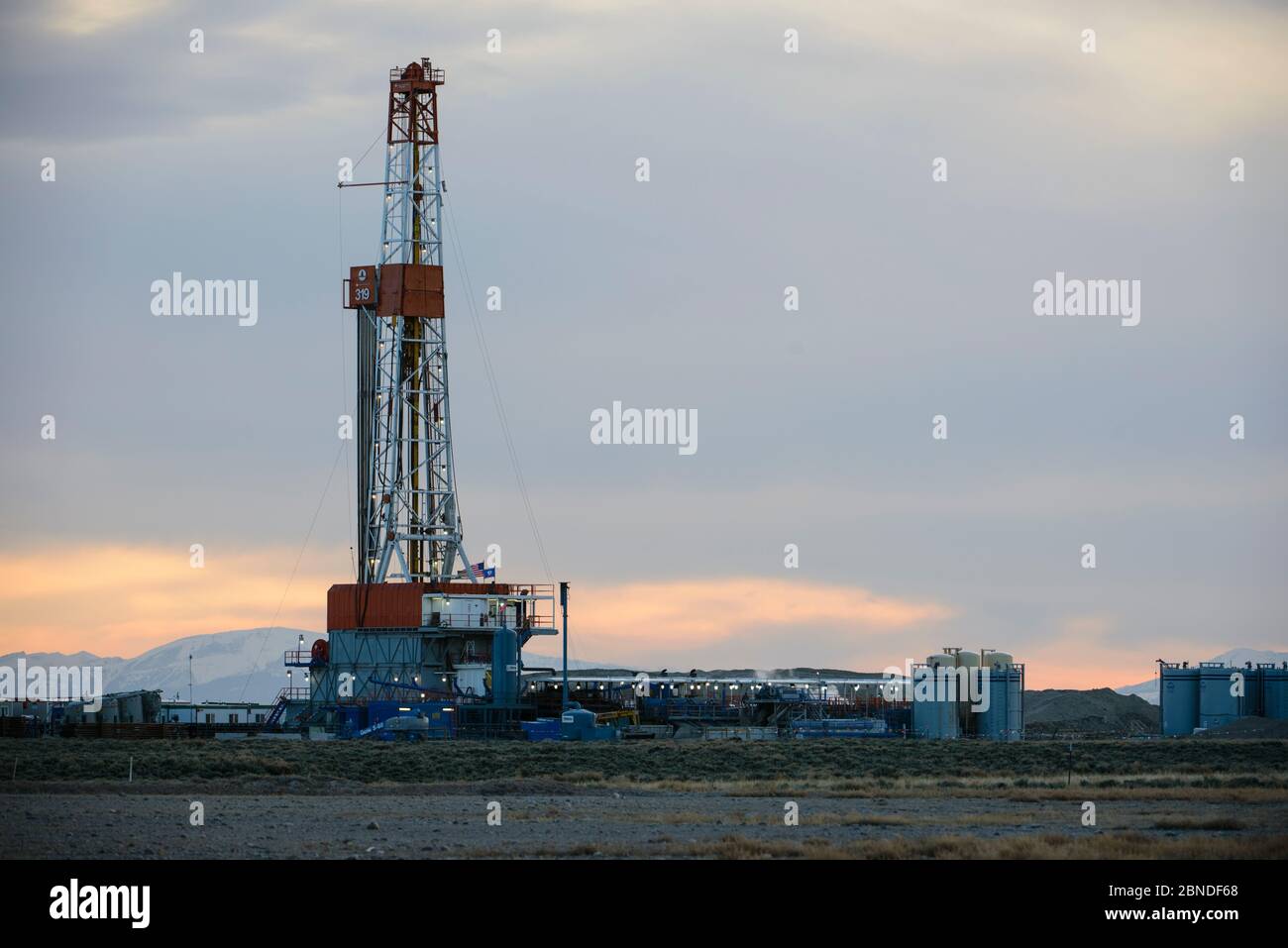 Natural gas drilling rigs on Pinedale Mesa at sunset, Sublette County ...