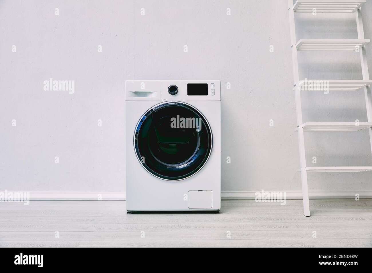modern washing machine near rack and white wall in bathroom Stock Photo ...
