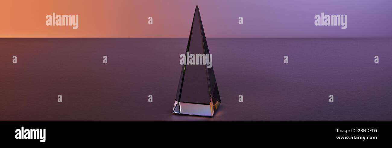 crystal transparent pyramid with light reflection on dark purple ...