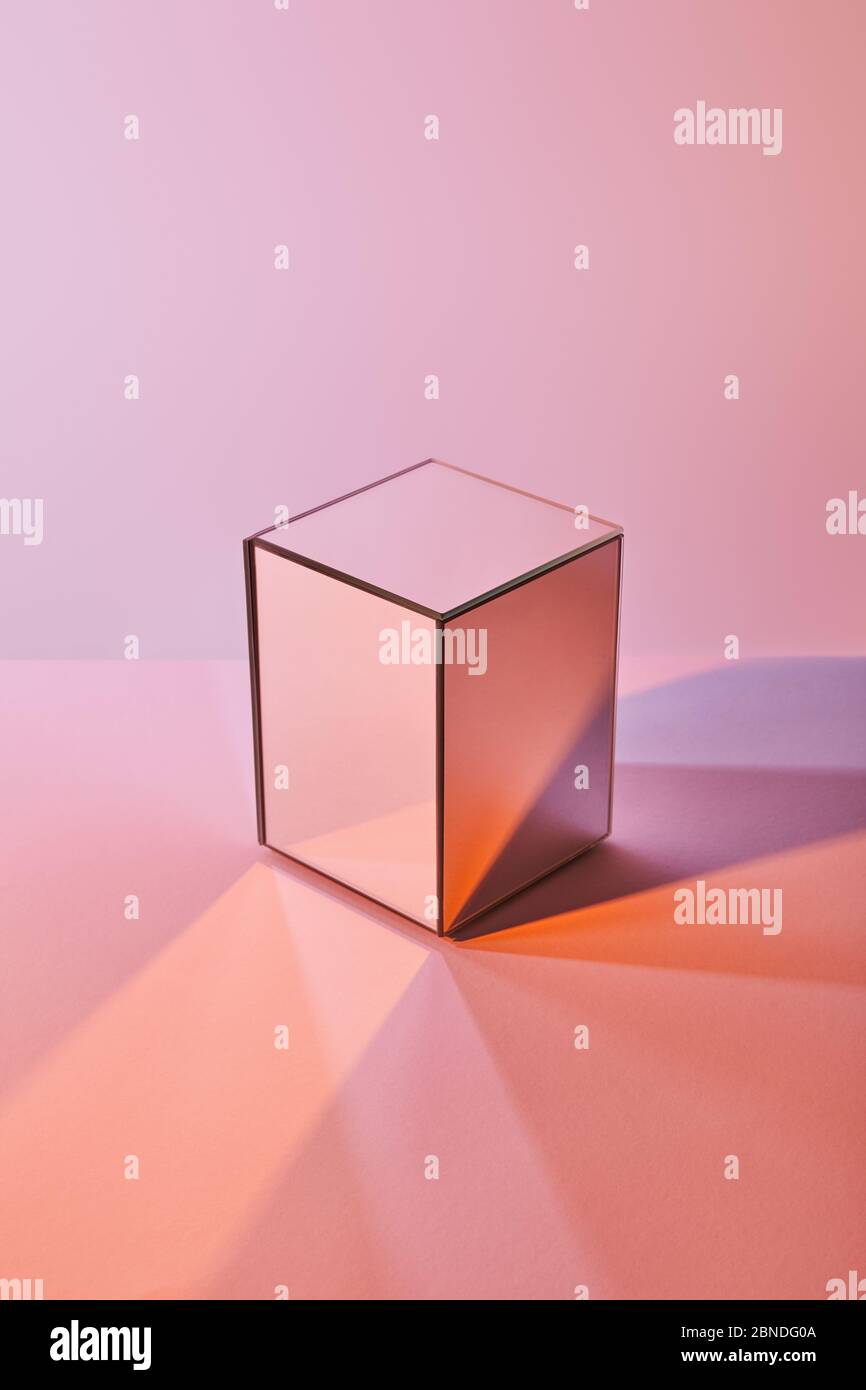 cube with light reflection on surface on violet and pink background ...