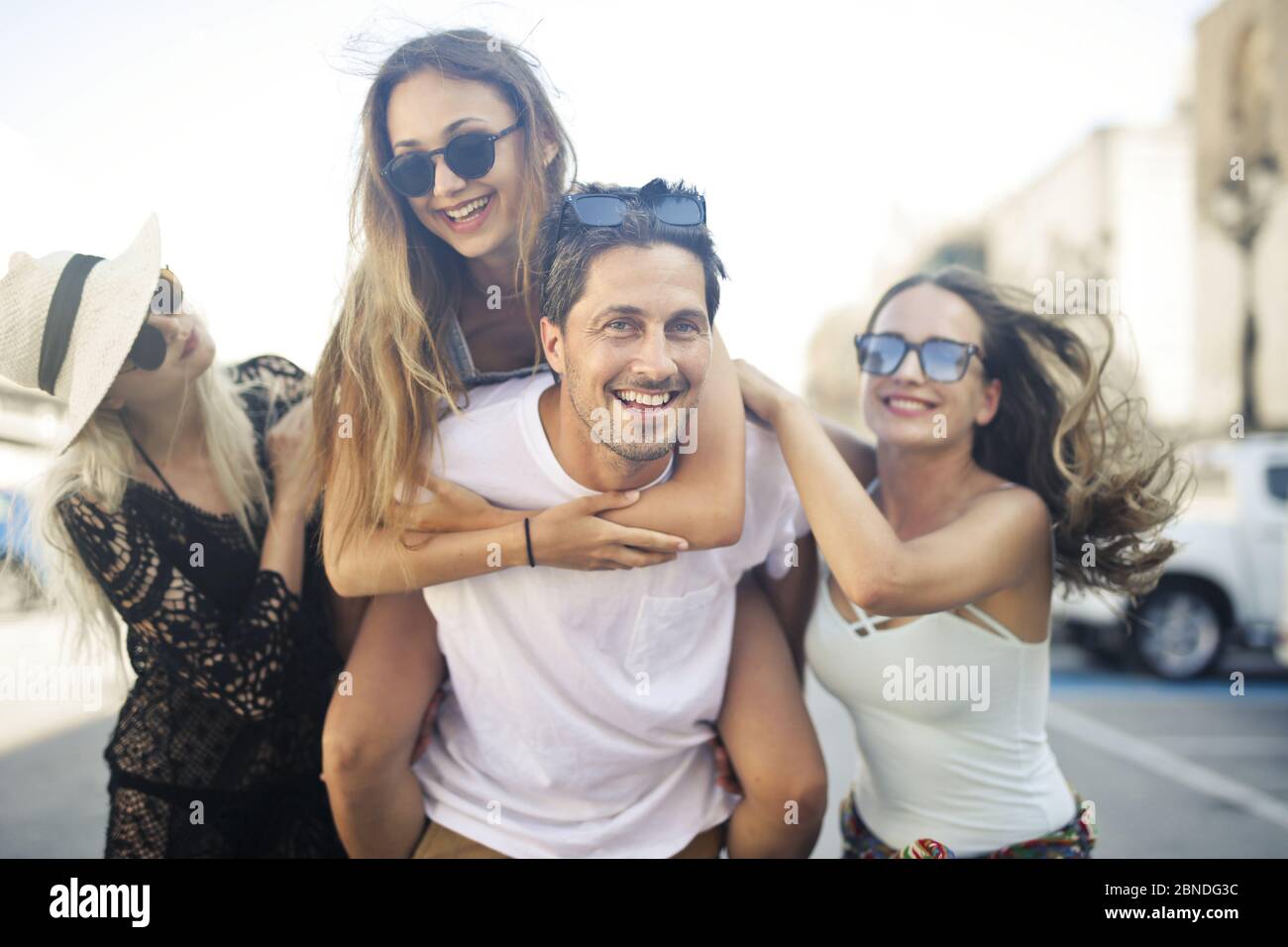 Happy friends enjoying their vacation together in a city Stock Photo ...