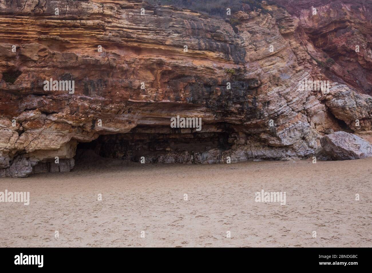 Beach of Nazare, Portugal. Cliff and sand Stock Photo - Alamy