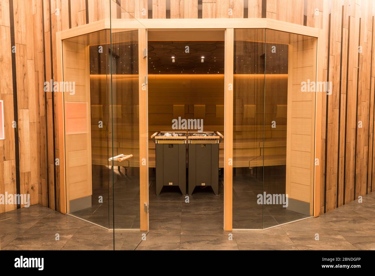 Beautiful sauna room design with a wooden bench and sauna rocks in the ...