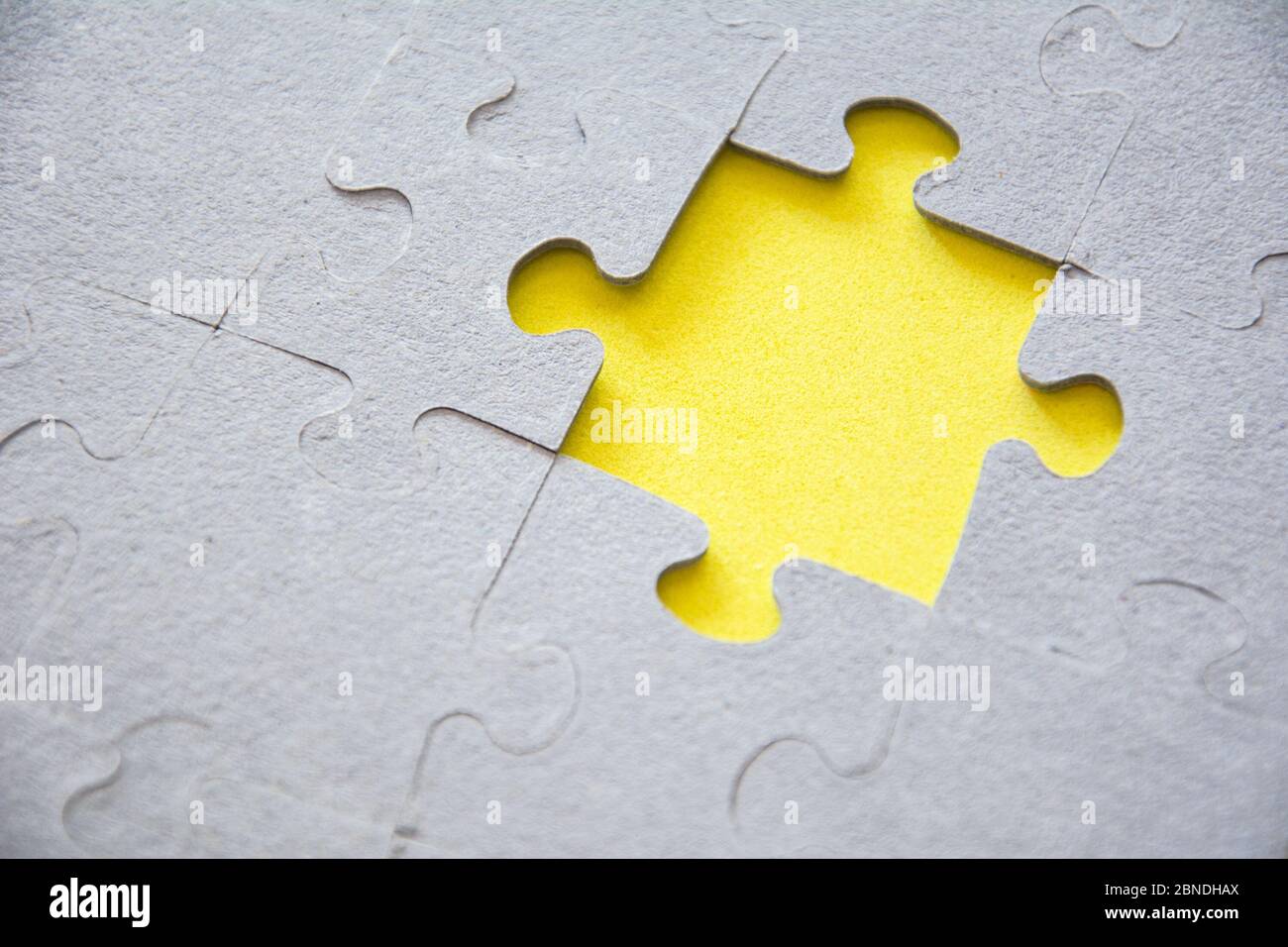 One piece missing from jigsaw puzzle on yellow background Stock Photo ...