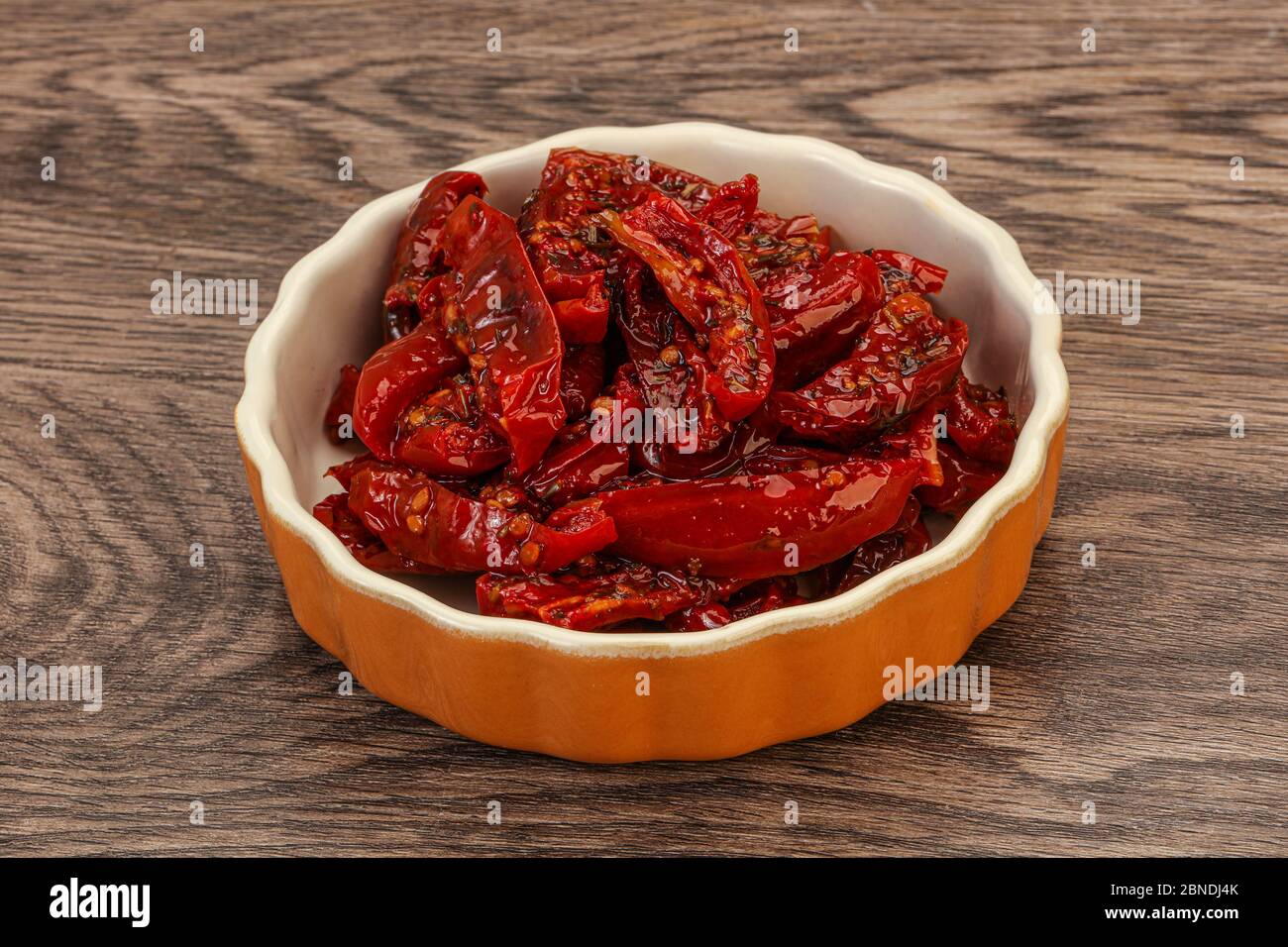 Dried tomato with olive oil and herbs Stock Photo - Alamy