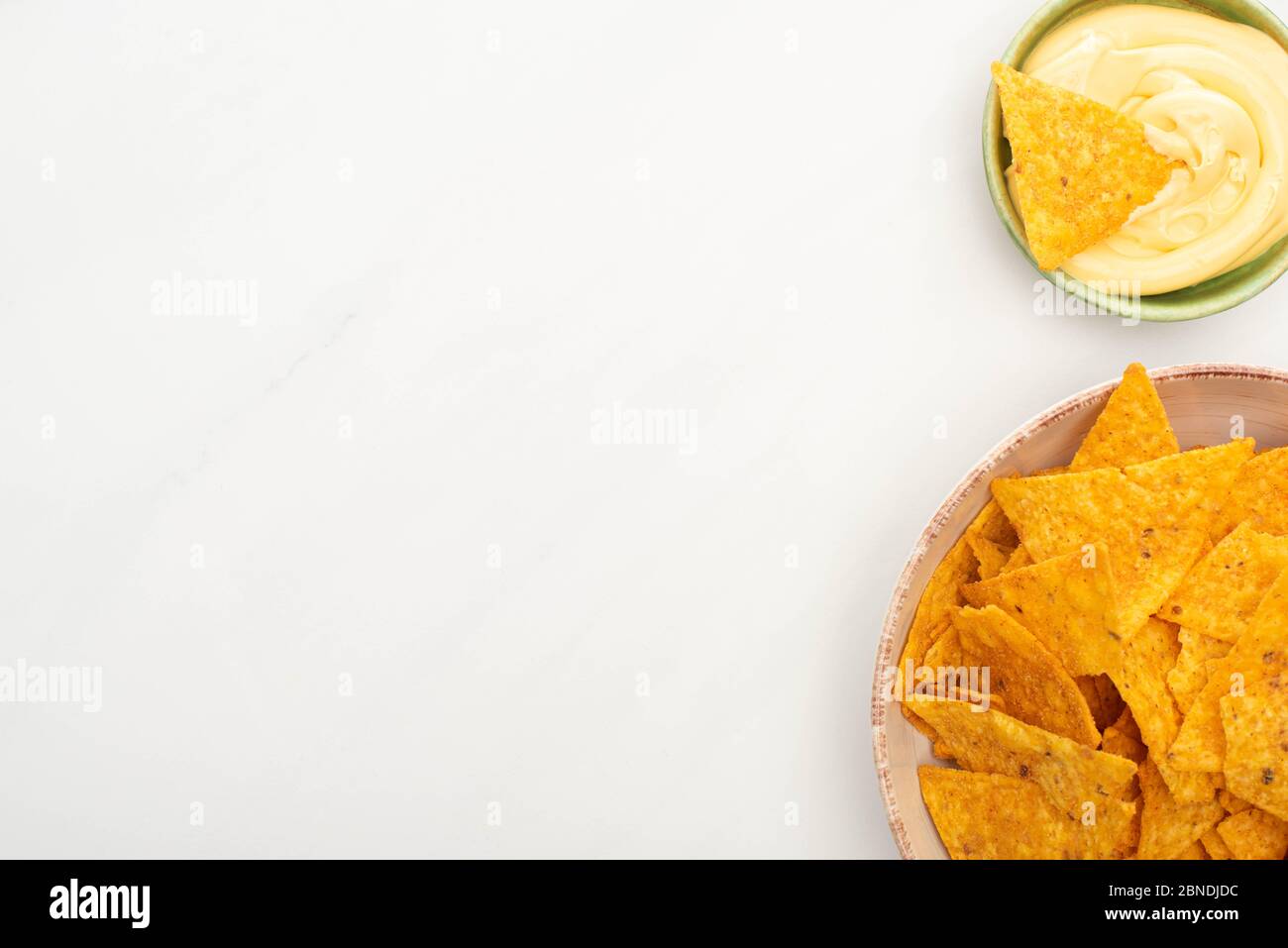 top view of corn nachos with cheese sauce on white background Stock ...
