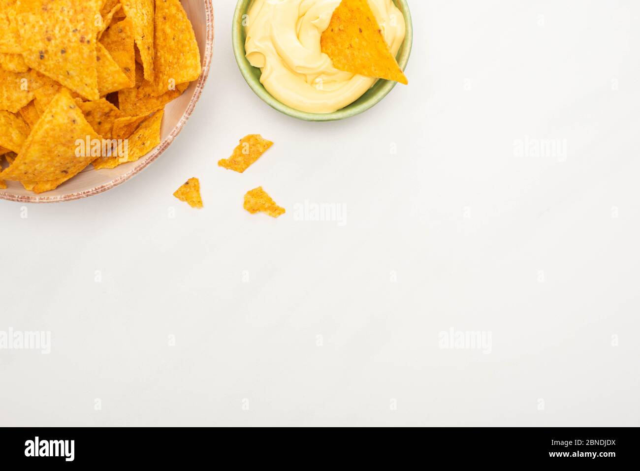 top view of corn nachos with cheese sauce on white background Stock ...