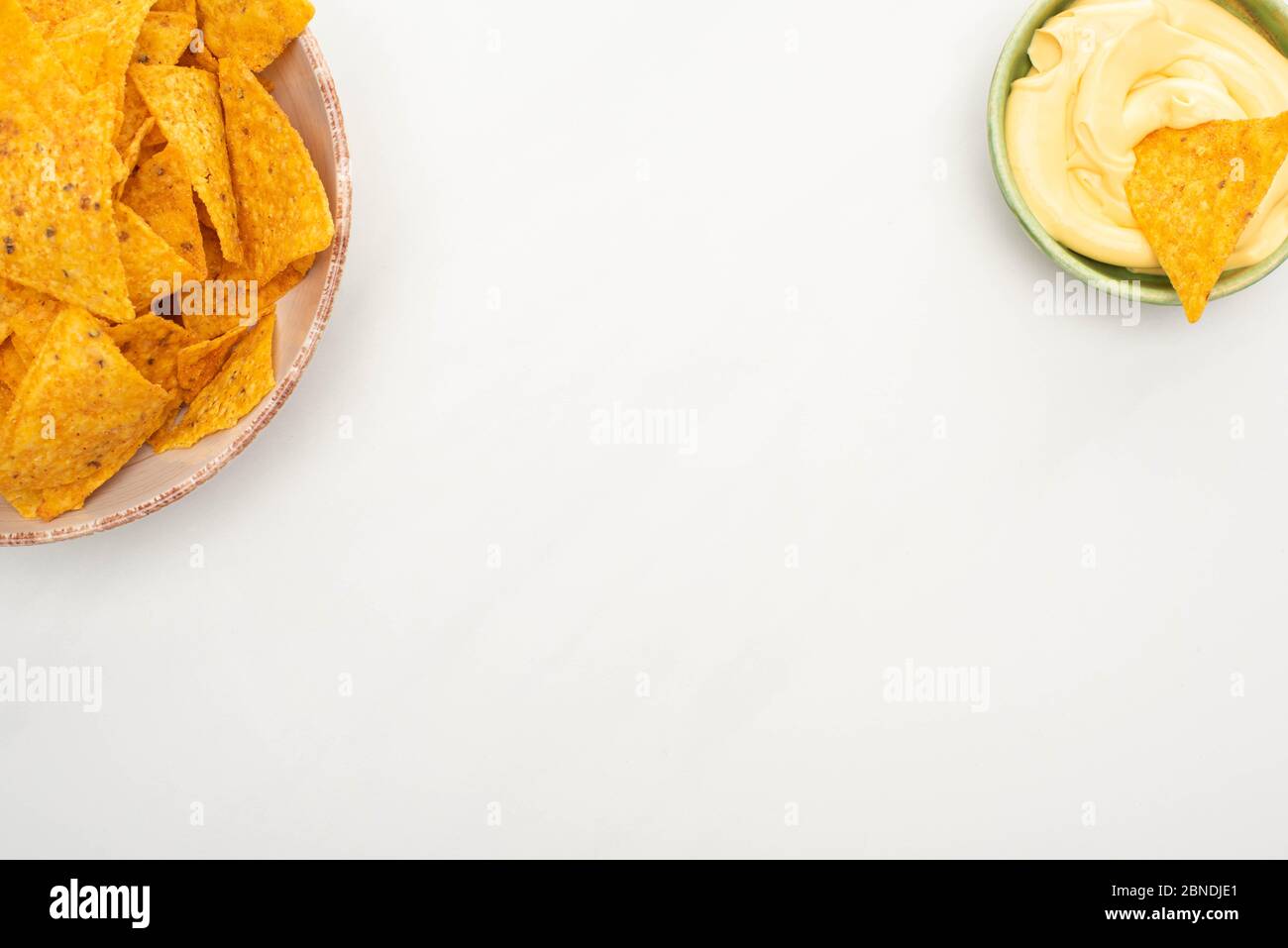 top view of corn nachos with cheese sauce on white background Stock ...