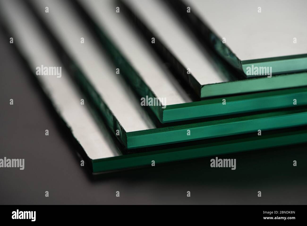 close up view of mirror pieces in stack on dark background Stock Photo ...