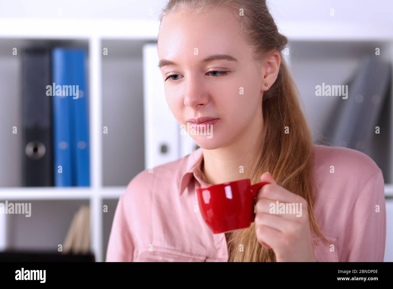 Lady holding red cup Stock Photo - Alamy