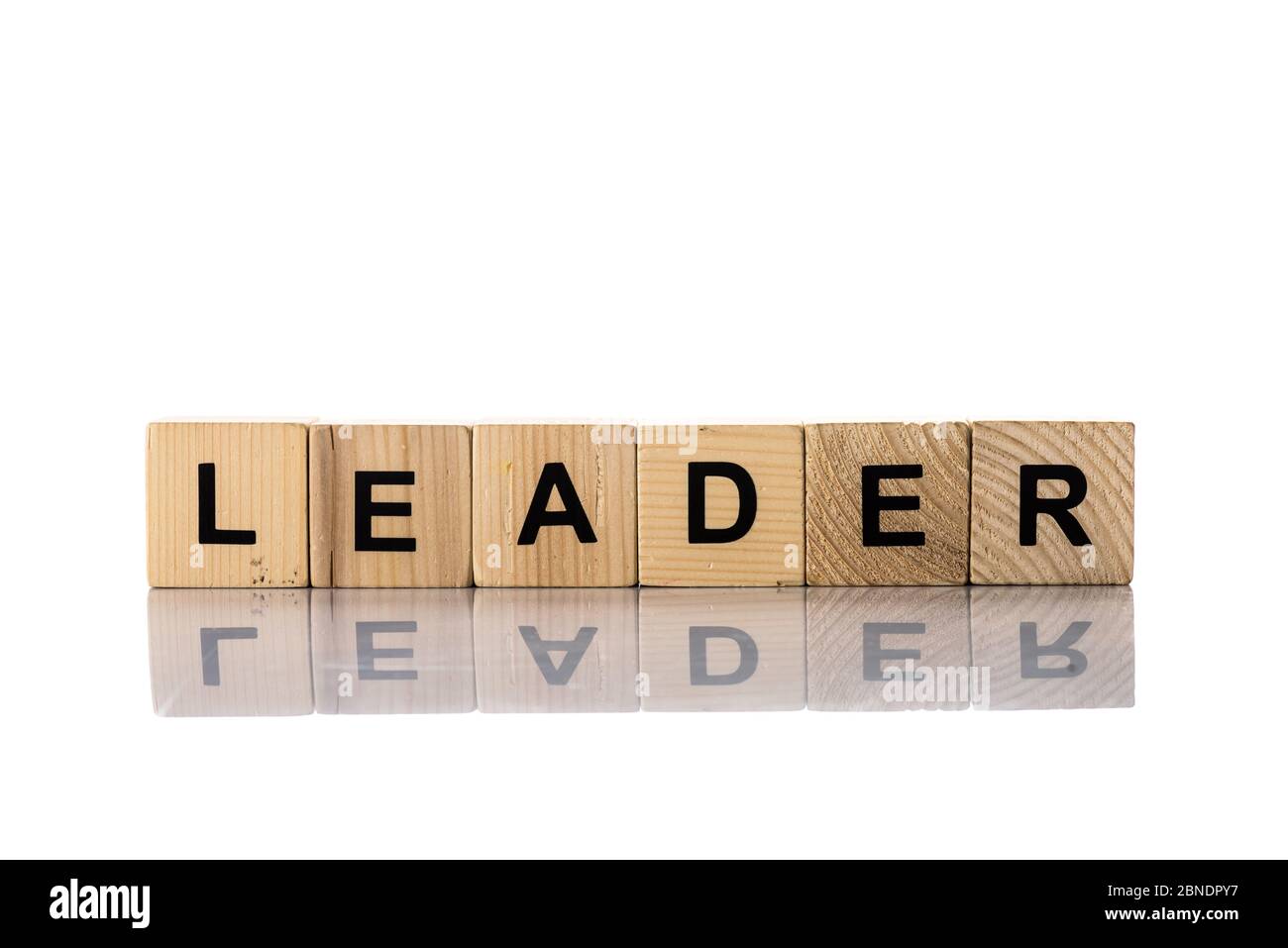 Wooden cubes with leader lettering on white background Stock Photo - Alamy
