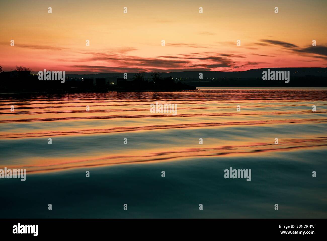 Mild waves in a lake during the sunset with cinematic colorgrading ...