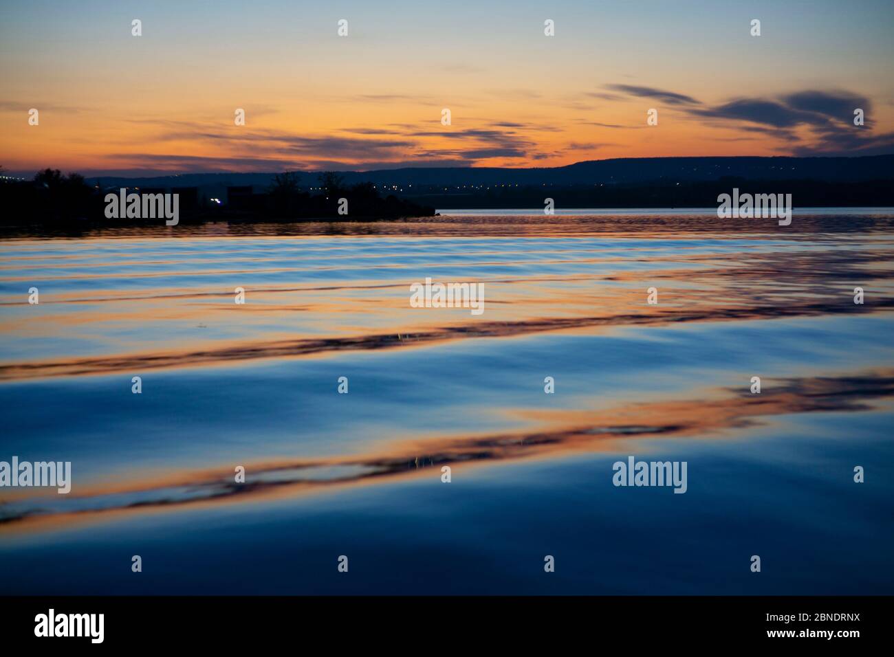 Mild waves in a lake during the sunset with cinematic colorgrading ...