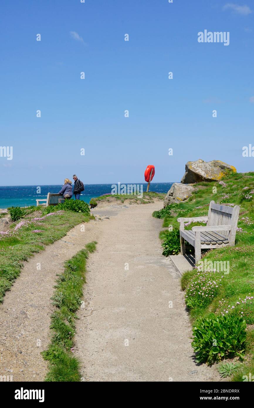 Walkers on cliff top path Stock Photo - Alamy