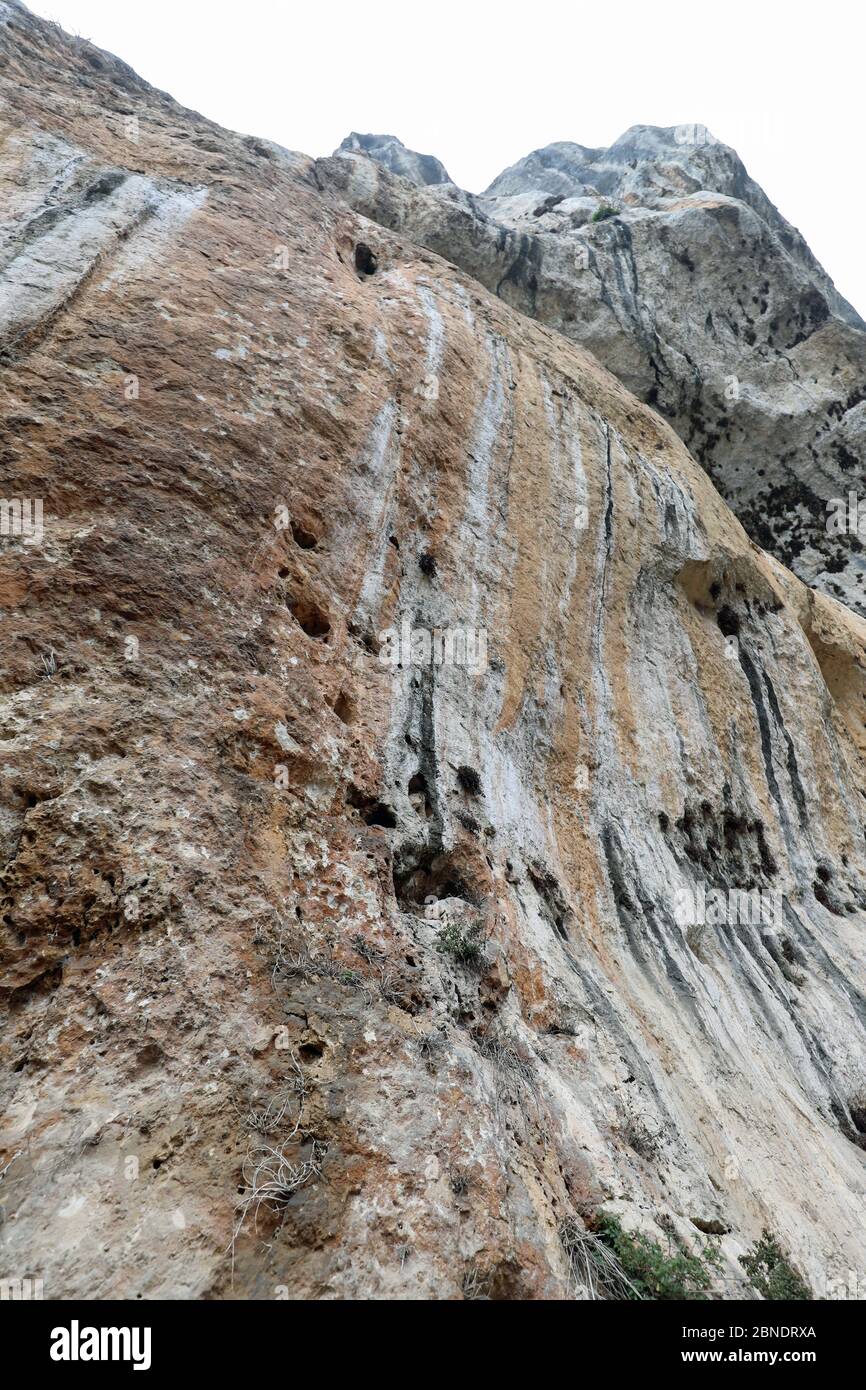 high imposing steep limestone wall overhanging rock without people and ...