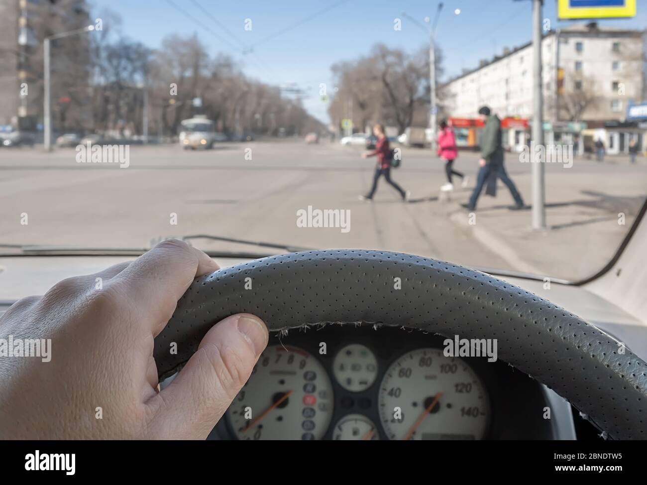 view from the car, the man's hand on the steering wheel of the car ...