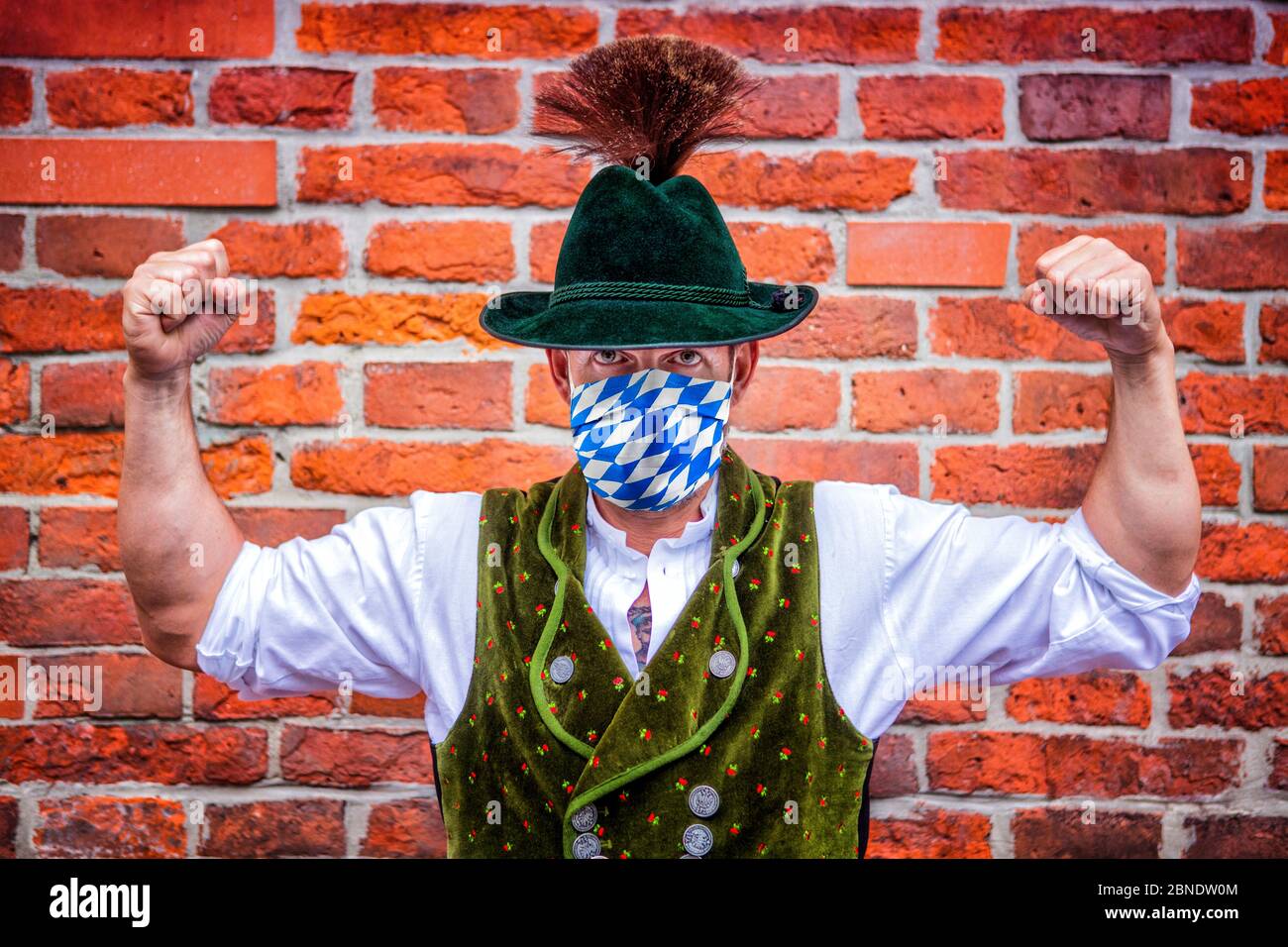bavarian man flexing his muscles and wearing a protective blue white ...