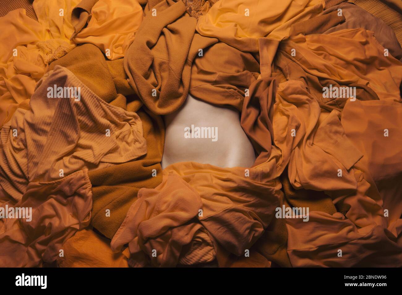 Woman buried under clothes hi-res stock photography and images - Alamy