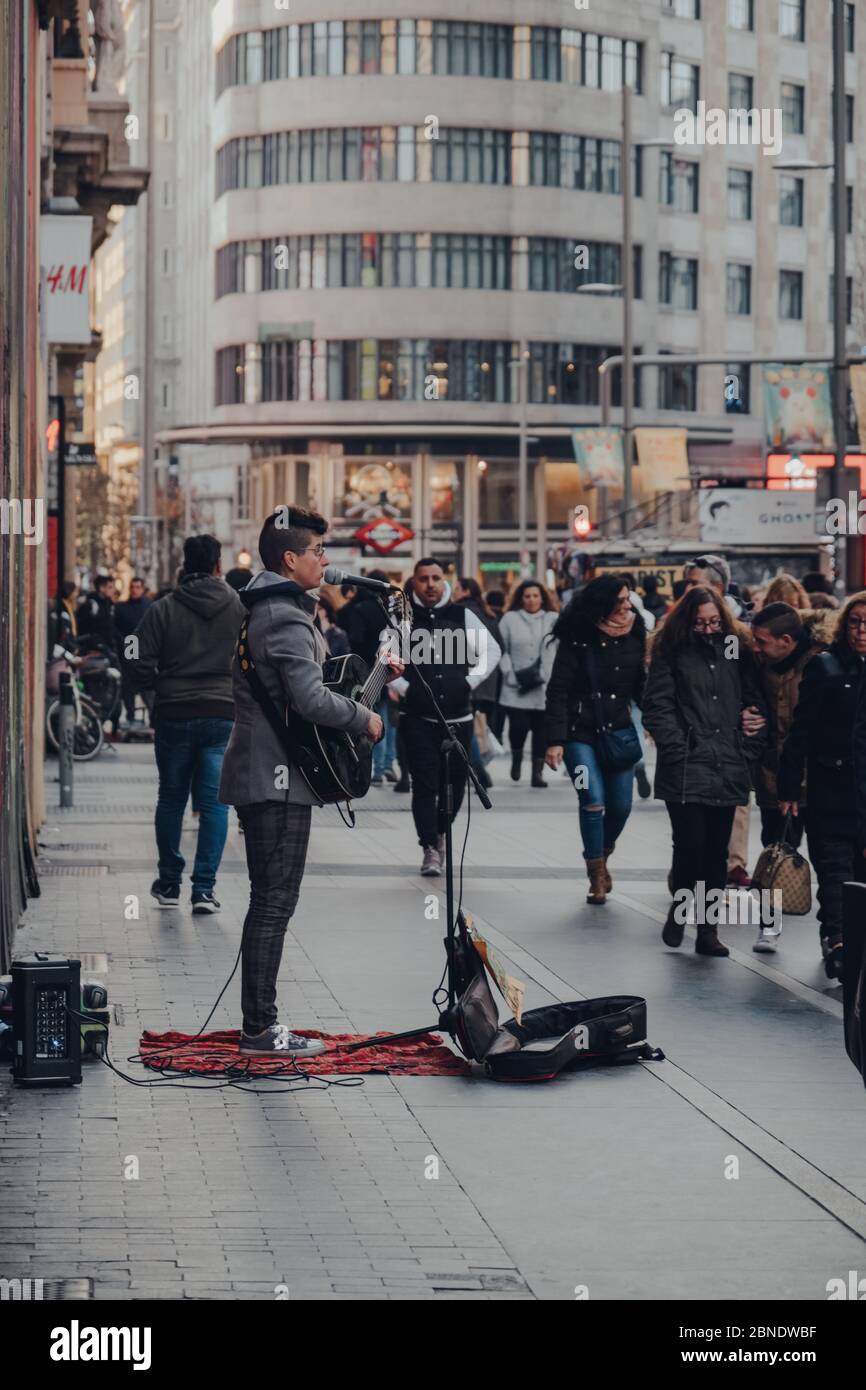 Madrid, Spain - January 26, 2020: Busker singing and playing guitar on ...