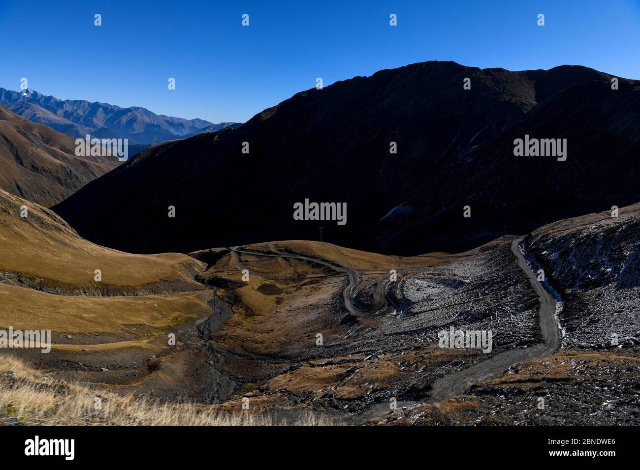 Caucasus, Georgia, Tusheti region, Shenako. A road goes down between ...