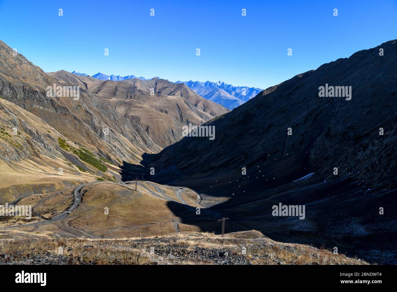 Caucasus, Georgia, Tusheti region, Shenako. A road goes down between ...