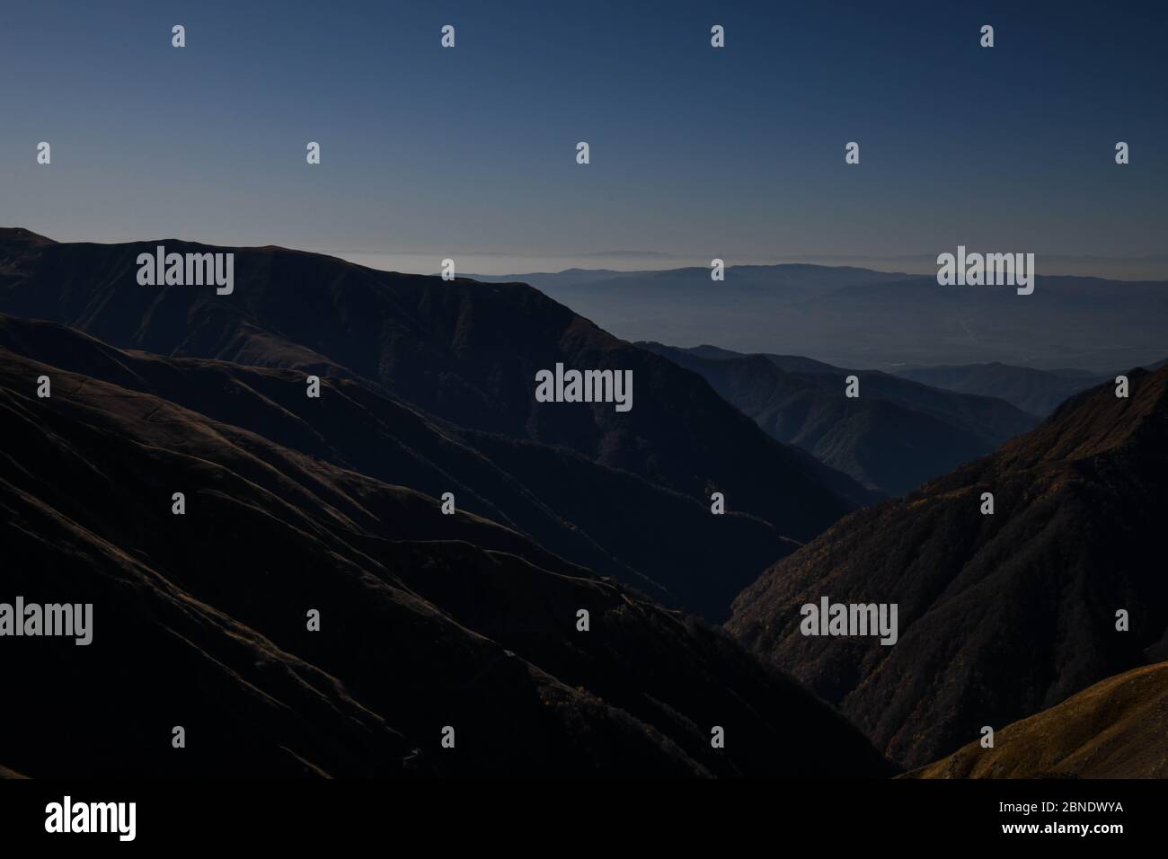 Caucasus, Georgia, Tusheti region, Shenako. A road goes down between ...