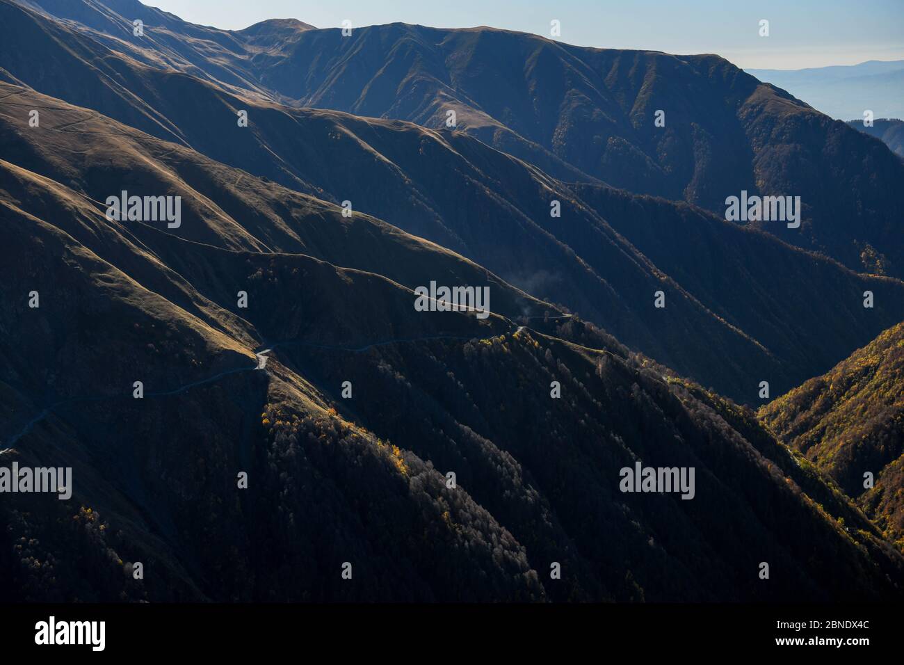 Caucasus, Georgia, Tusheti region, Shenako. A road goes down between ...