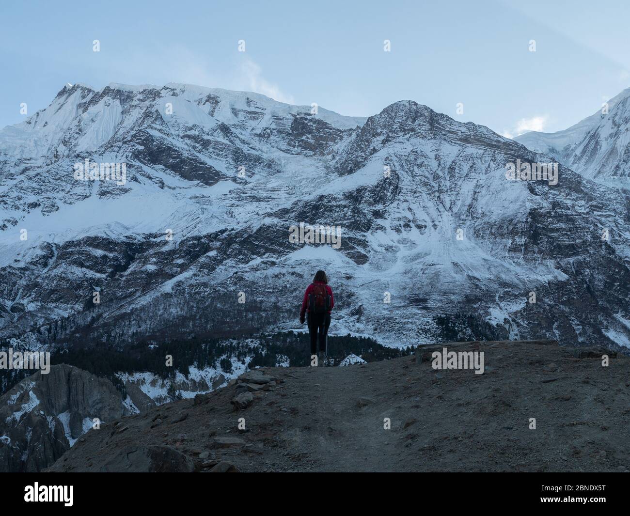 Behind shot of the hiker and the mesmerizing view of the mountains ...