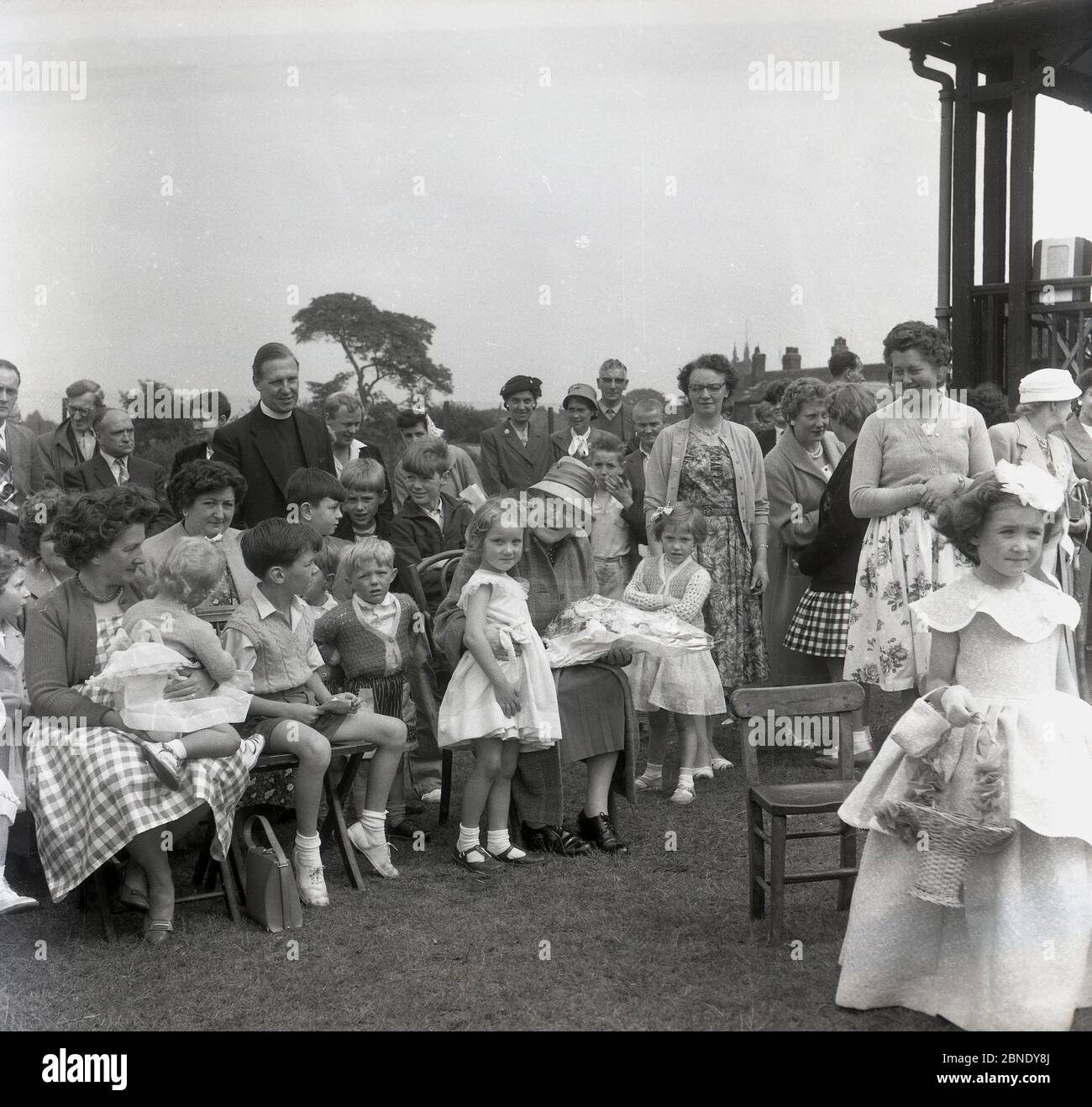 1950s, historical, on the grass outside a wooden sports pavillion at ...