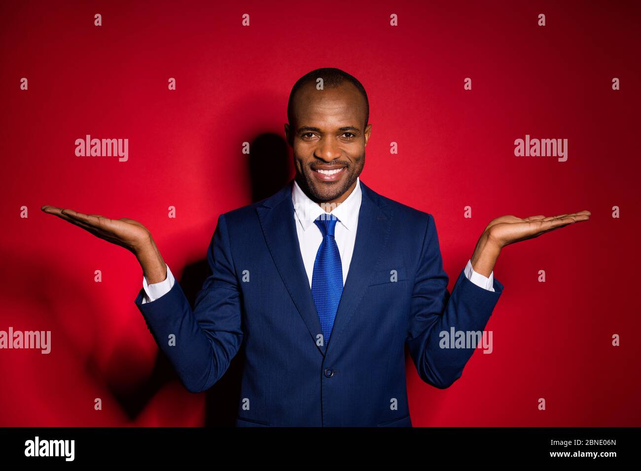 Photo of handsome attractive dark skin business guy holding two open ...