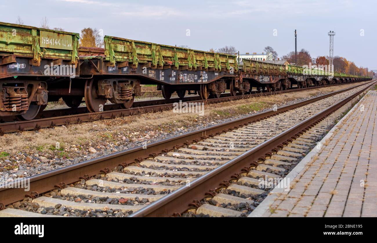 Landscape with railroad track and cargo wagons Stock Photo - Alamy