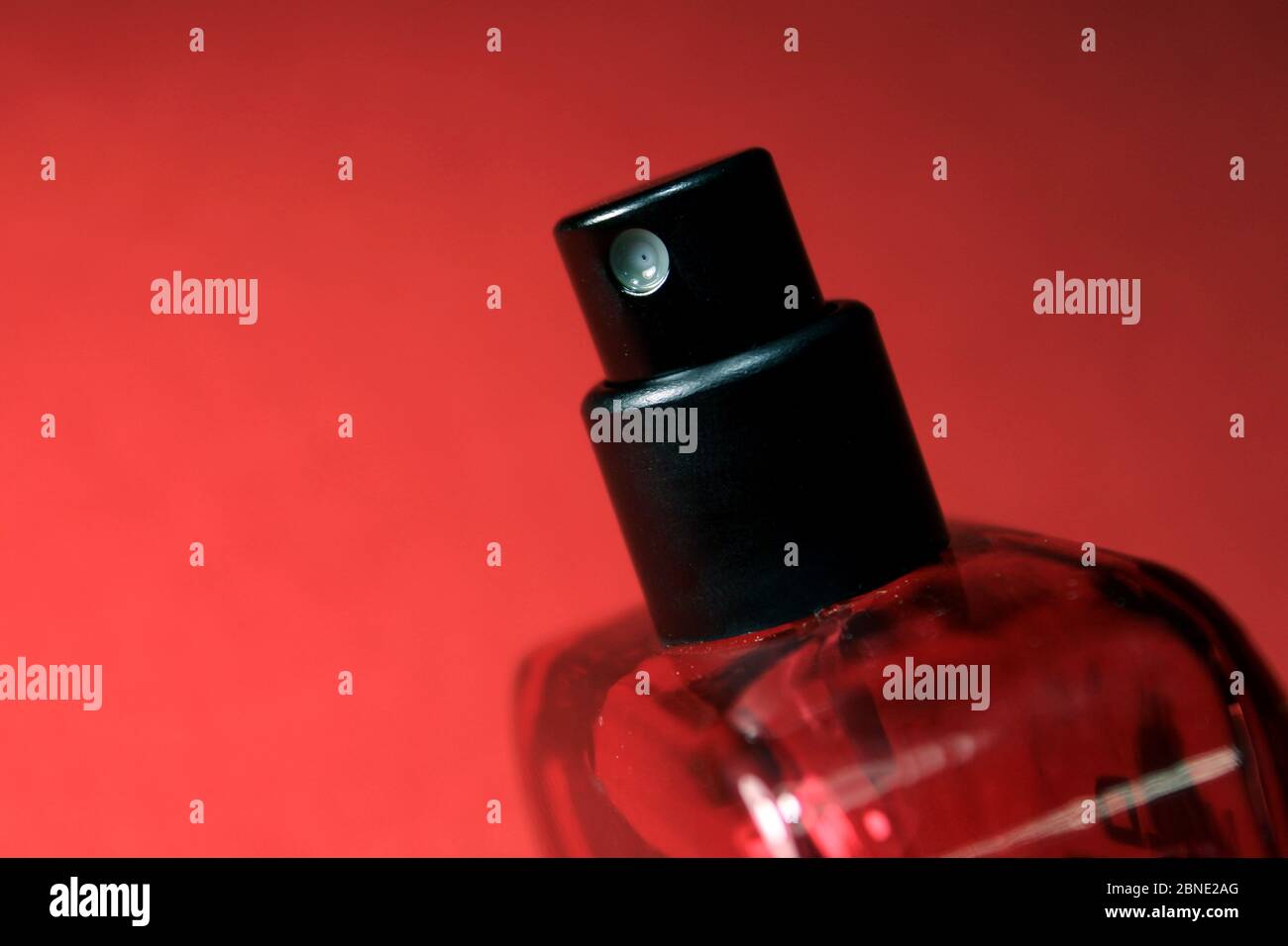 Red color men perfume bottle isolated on red silk background. Red ...
