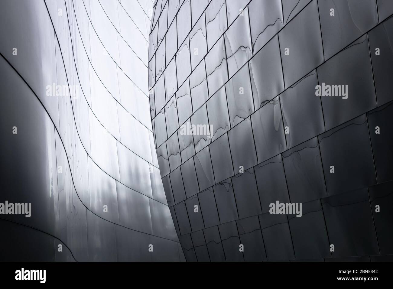 Grayscale shot of a reflective glass of a modern architectural building ...